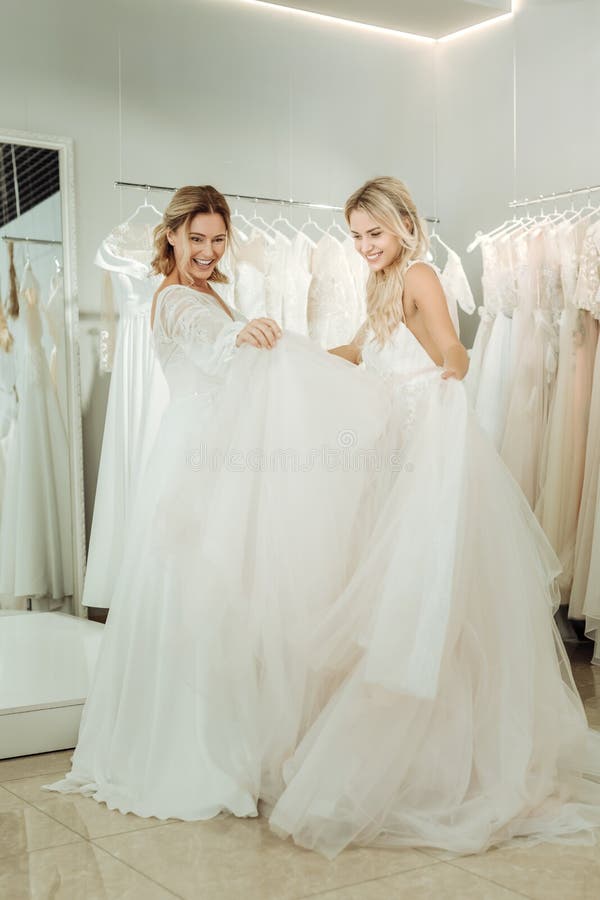Two Brides Looking at the Dresses of Each Other. Stock Image - Image of ...