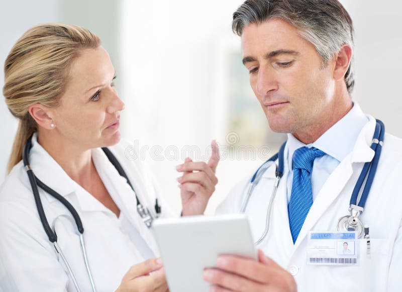Comparing Medical Notes. Two Doctors Talking Together Over a Digital ...