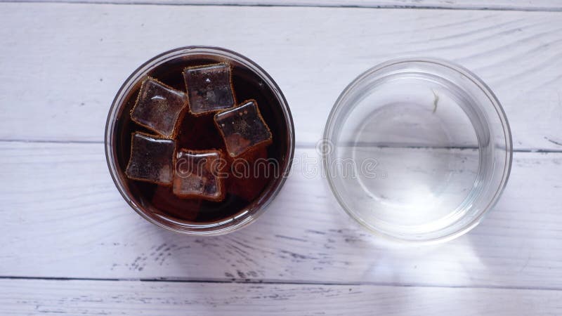 Comparing Soft Drinks with Glass of Water on Table Stock Footage ...