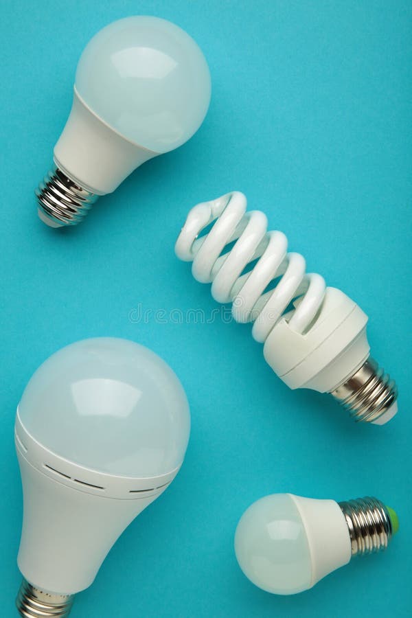 Comparison of Different Light Bulbs on Blue Background Stock Image ...