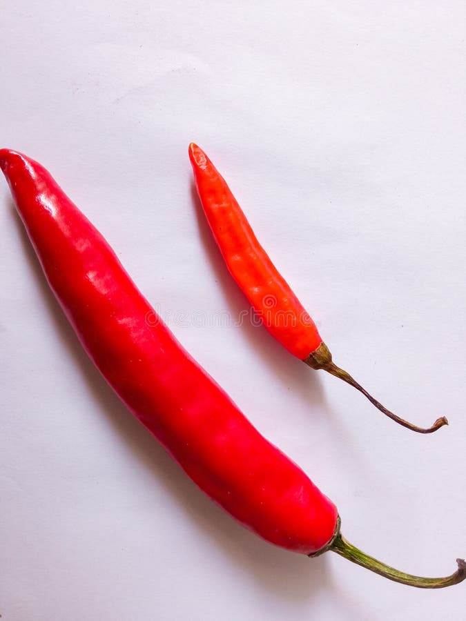 Comparison between Large Red Chilies and Cayenne Pepper Isolated on ...