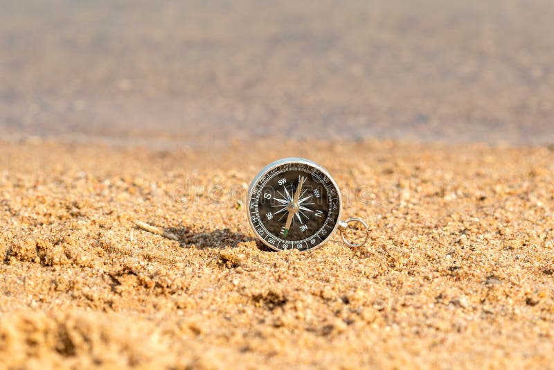 Compass On The Beach With Sand And Sea Stock Image - Image of adventure ...