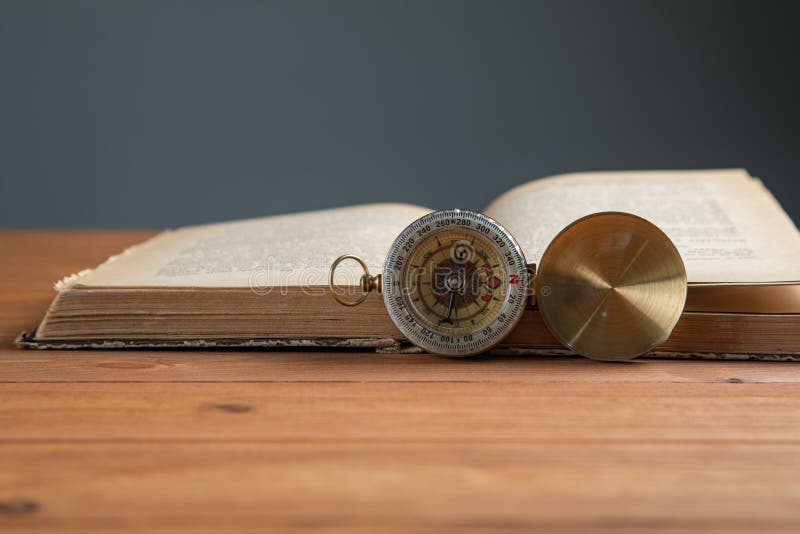 Compass and an old book stock photo. Image of direction - 19160960