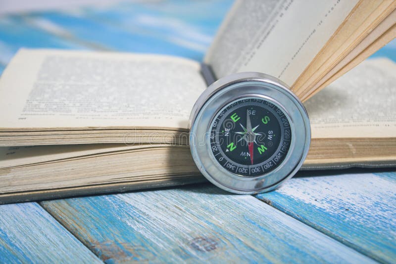 Compass and Book on the Table Stock Photo - Image of deckle, book ...