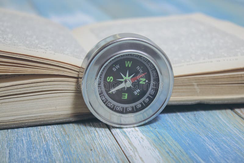 Compass and Book on the Table Stock Image - Image of wooden, concept ...