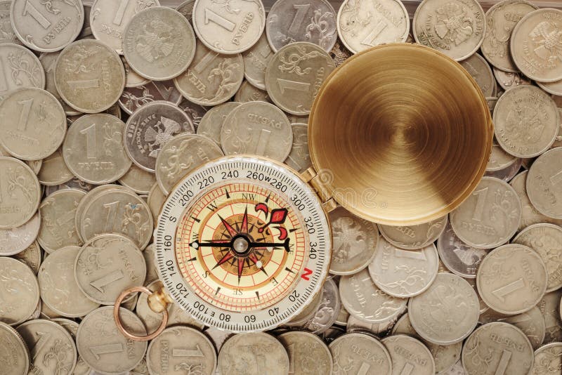 Compass on a coins stock photo. Image of investment - 133016390