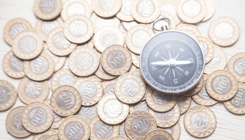 Compass and Coins on the White Desk Stock Photo - Image of gold ...