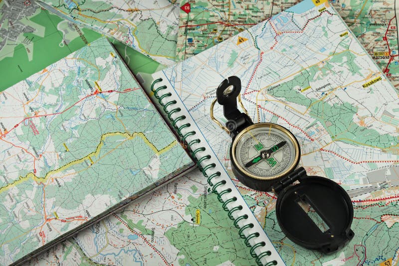 Compass and small atlas stock photo. Image of travel, world - 4817848