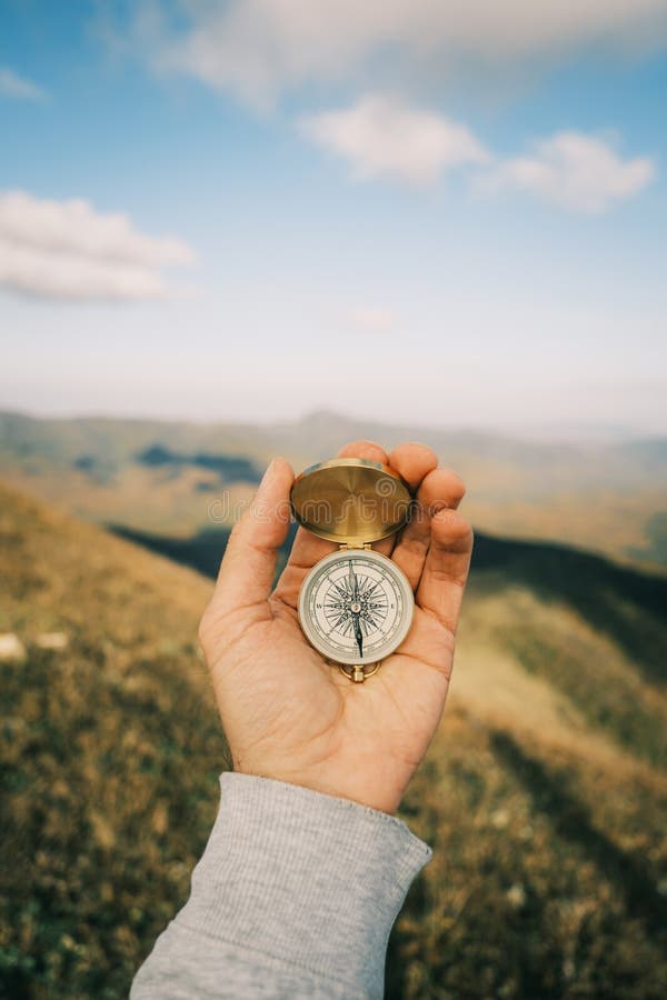 Compass in Hand in the Background Mountain Landscape. Stock Photo ...