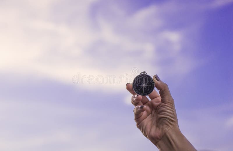 Compass in Hand on the Background of the Sky with Clouds Stock Photo ...