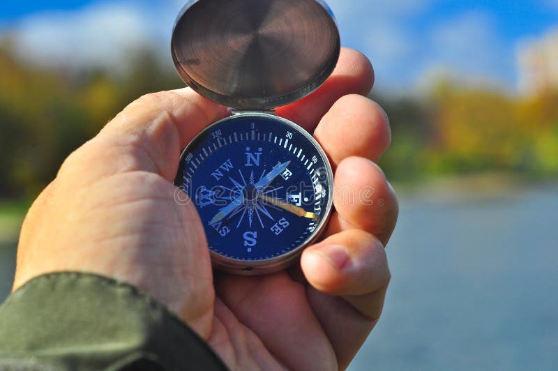 Compass in hand. stock photo. Image of east, direction - 56417734