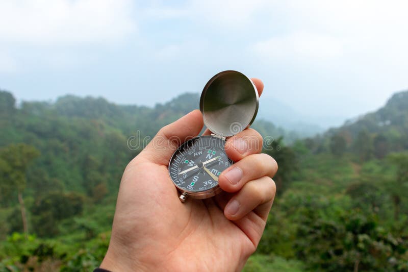 A compass held by hand stock image. Image of hill, lost - 278923535