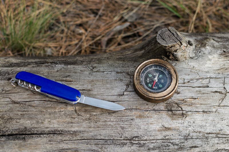 Compass and Knife for Survival in Forest on Log. Stock Photo - Image of ...