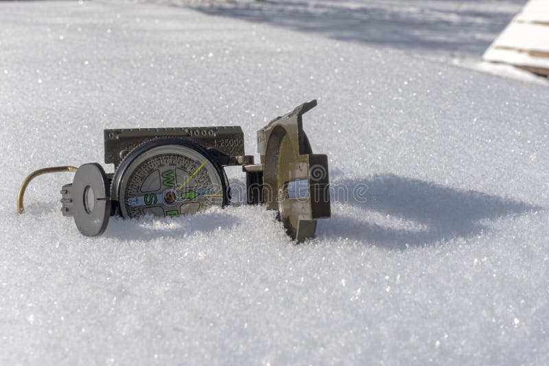 Compass Lies in the Fresh Snow Stock Photo - Image of cold, magnetic ...