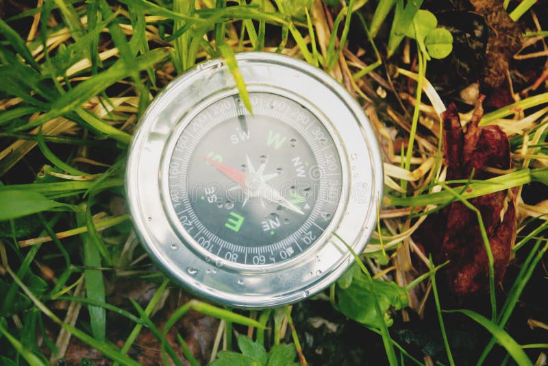 Compass Lying on the Ground Stock Photo - Image of hand, holding: 164619602