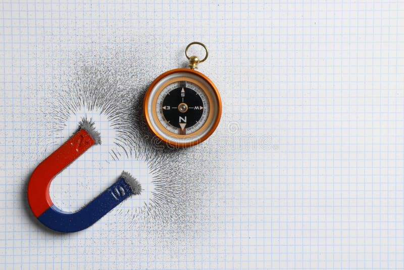 Compass and Magnet with Iron Powder on Paper Stock Image - Image of ...