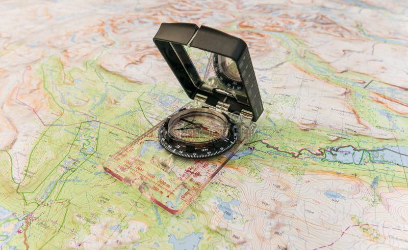 Compass on Map for Finding Way in Wilderness and Life. Stock Photo ...
