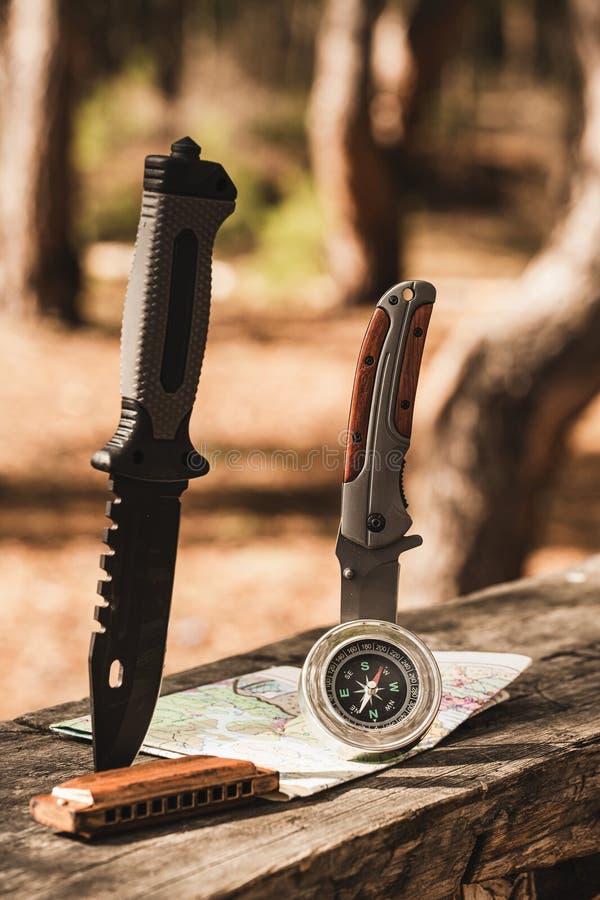Compass, Map, Harmonica and Knife on a Wooden Table in the Woods ...
