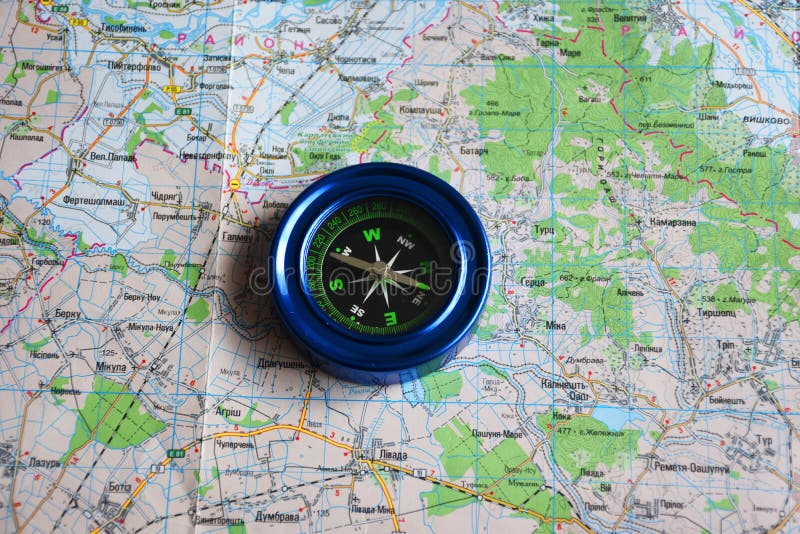 Compass on the map stock photo. Image of unfolded, photograph - 146287318
