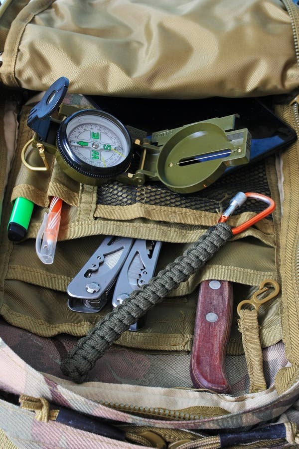 Compass, Multitool and Knife in a Backpack Stock Photo - Image of black ...