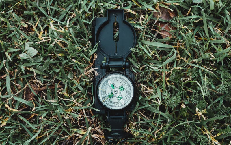 Compass Over Ground and Grass Stock Photo - Image of environmental ...