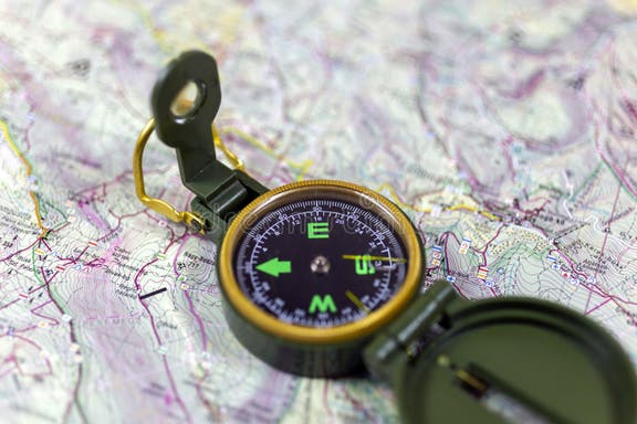 Compass on a paper map stock photo. Image of symbol - 309446660