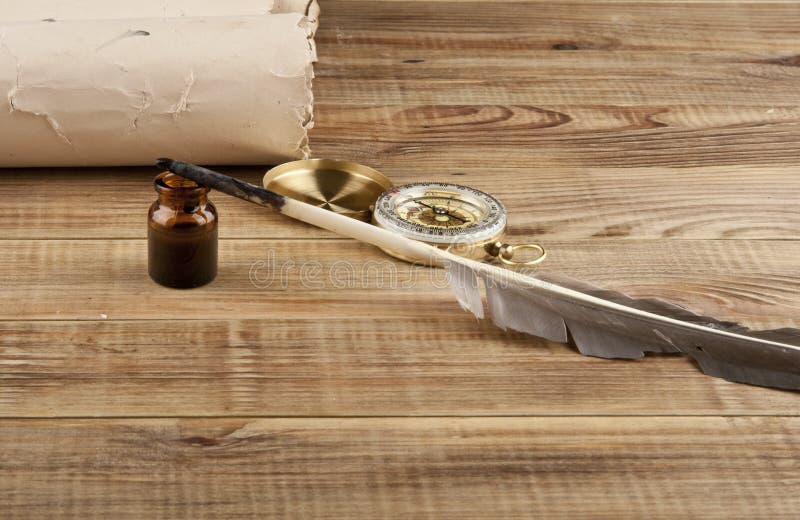 Compass, Pen with Ink and an Old Paper on a Wooden Stock Image - Image ...