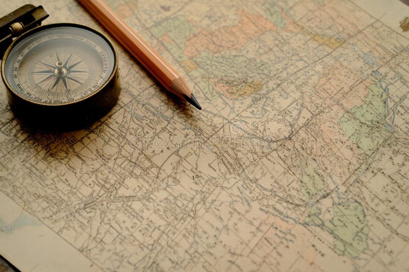 Vintage Exploration Tools Including a Compass and Pencil on an Antique ...