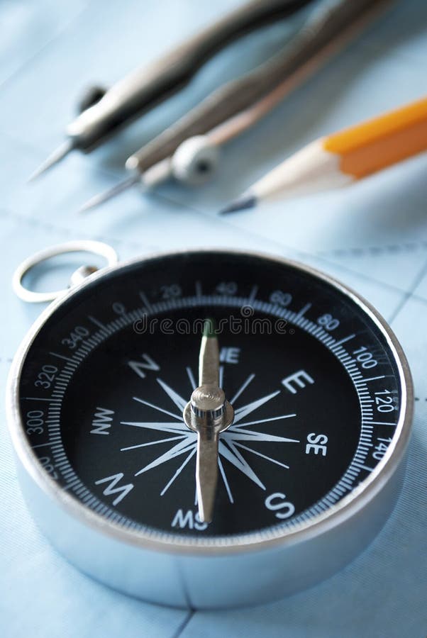 Compass and pencil on a map, Conceptual image of a magnetic compass and ...