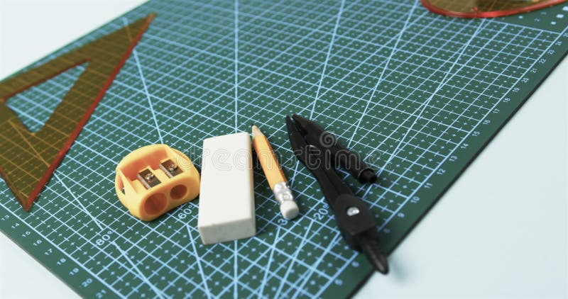 Compass, Pencil, Sharpener, Eraser and Rulers with Pad on White ...