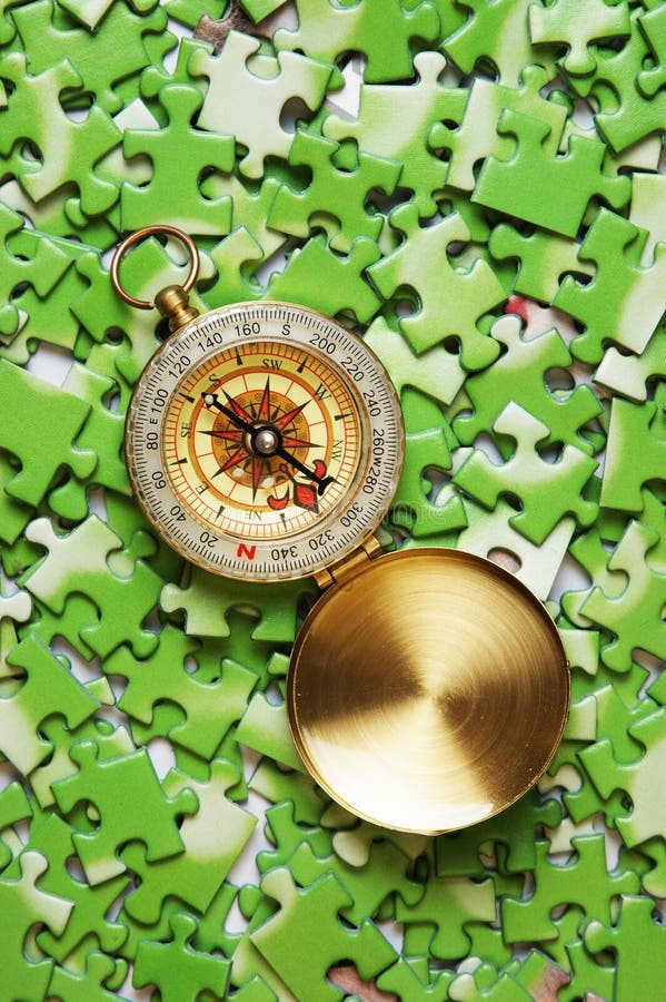 Compass on pile of puzzle stock image. Image of concept - 133005477