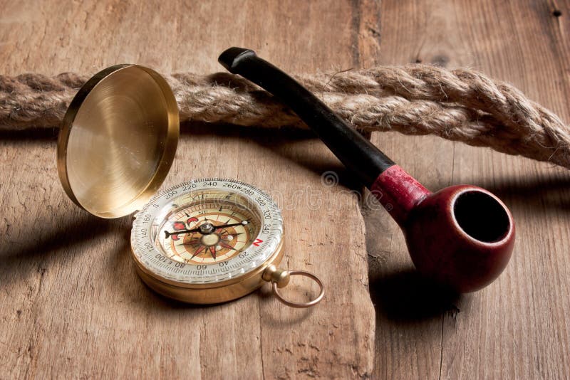 Compass and a Pipe with a Rope Stock Photo - Image of background ...
