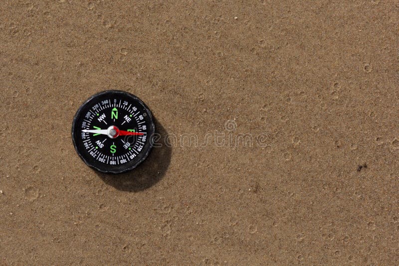 Compass Pointing East Laying on Sand Beach Stock Image - Image of ...