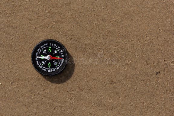 Compass Pointing East Laying on Sand Beach Stock Image - Image of ...