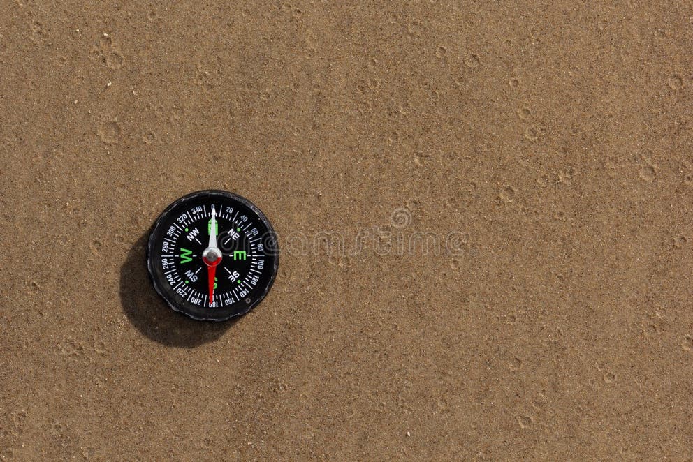 Compass Pointing South Laying on Sand Beach Stock Photo - Image of ...