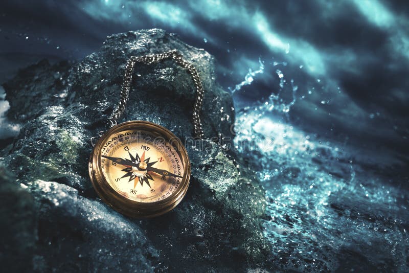 Compass on Rocks with a Dark Sky Stock Photo - Image of seashore, north ...