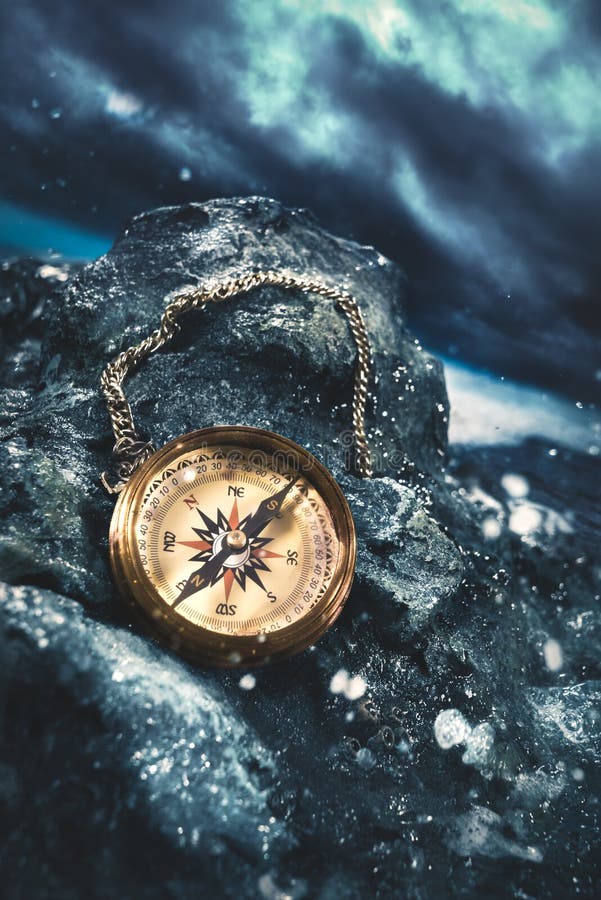 Compass on Rocks with a Dark Sky Stock Image - Image of compass ...
