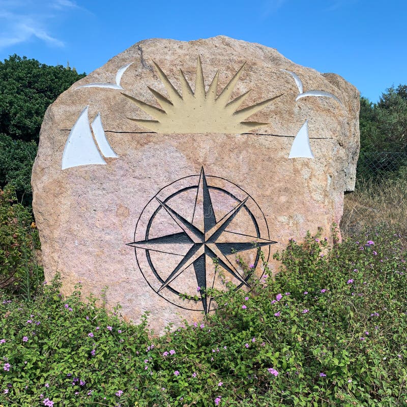 Compass Rose Painted on a Rock Surrounded by Green Bushes Editorial ...