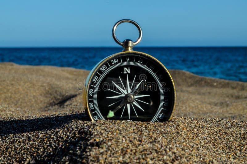 Compass on the Sand Beach stock photo. Image of sunny - 143673442