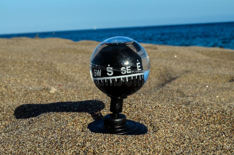 Compass on the Sand Beach stock photo. Image of vacation - 146681990
