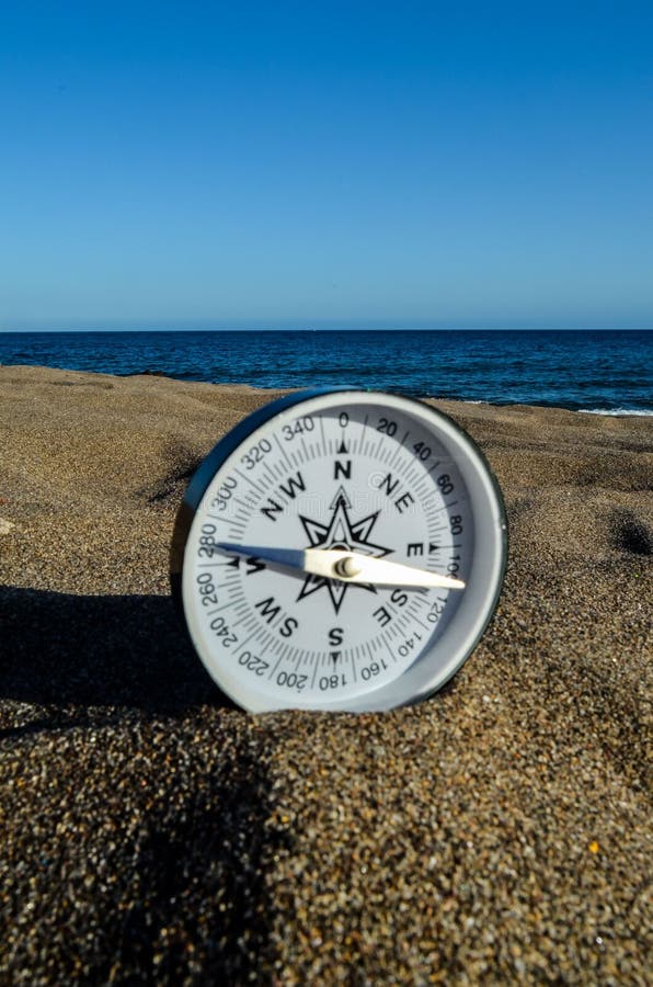 Compass on the Sand Beach stock image. Image of ocean - 154553841