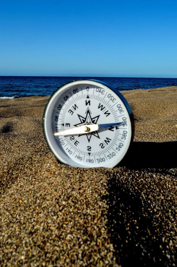 Compass on the Sand Beach stock photo. Image of vacation - 261371790