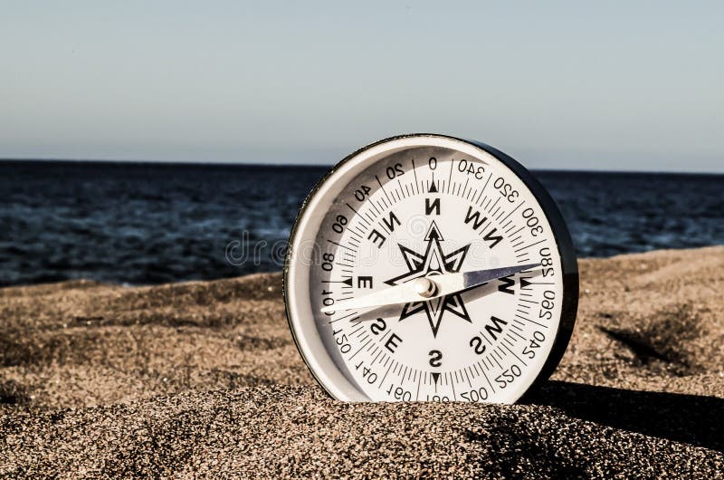 Compass on the Sand Beach stock photo. Image of holiday - 304790932