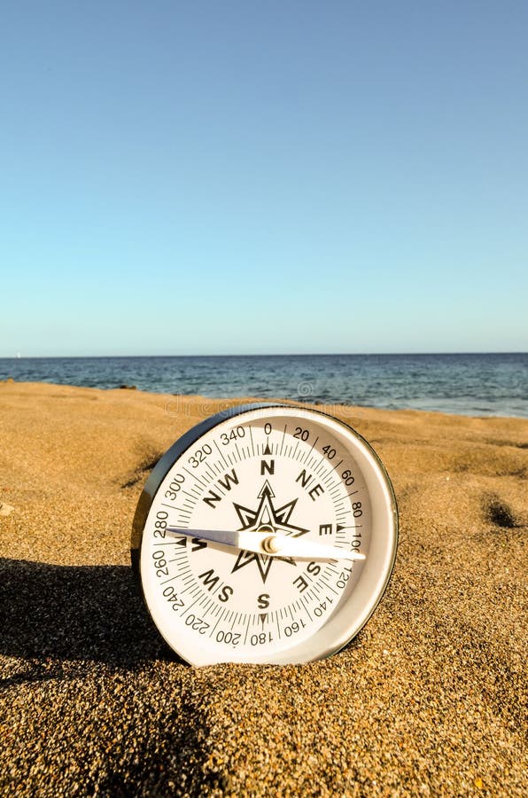Compass on the Sand Beach stock photo. Image of summer - 108426362