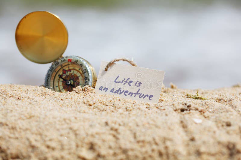 Compass in the Sand with Message - Life is an Adventure Stock Photo ...