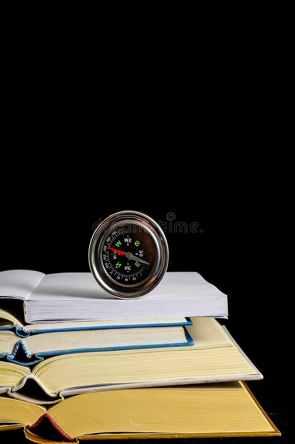 A Compass is on Top of a Stack of Books Stock Image - Image of stack ...