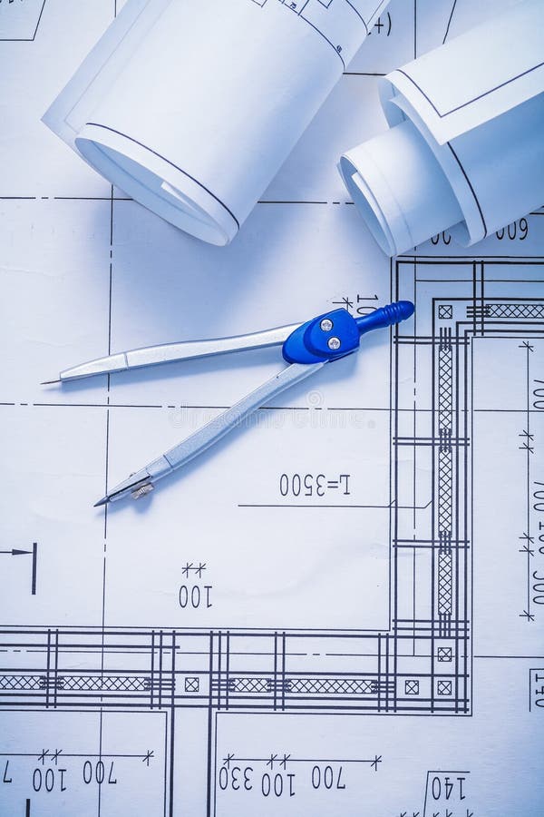 Compass and Two Rolled Up White Blueprints Stock Image - Image of ...