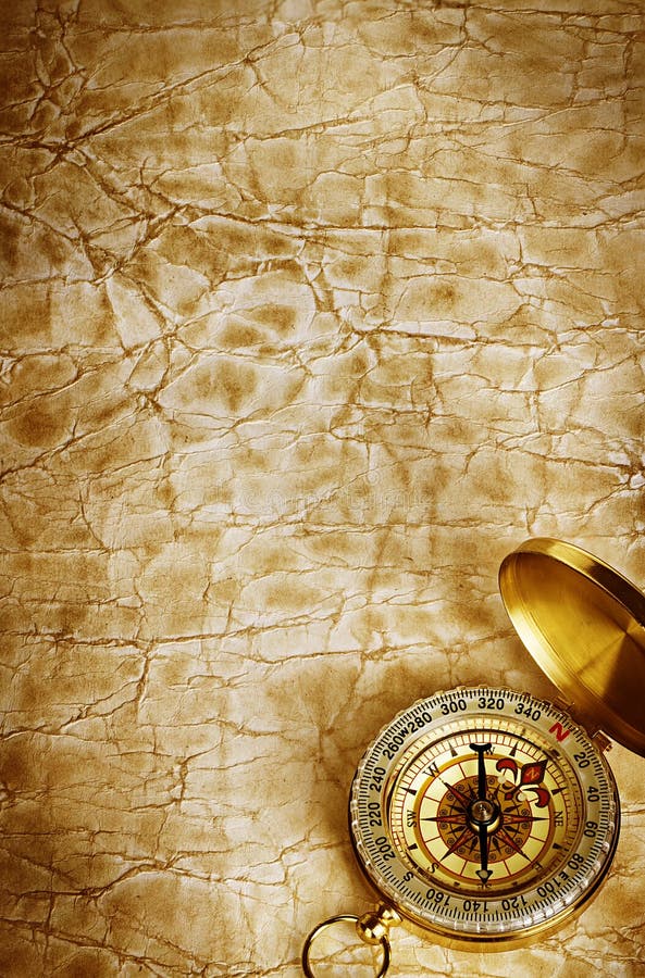 Ancient Brass Compass on Vintage Old Paper Background. Retro Stale ... Ancient Brass Compass on Vintage Old Paper Background. Retro Stale ...