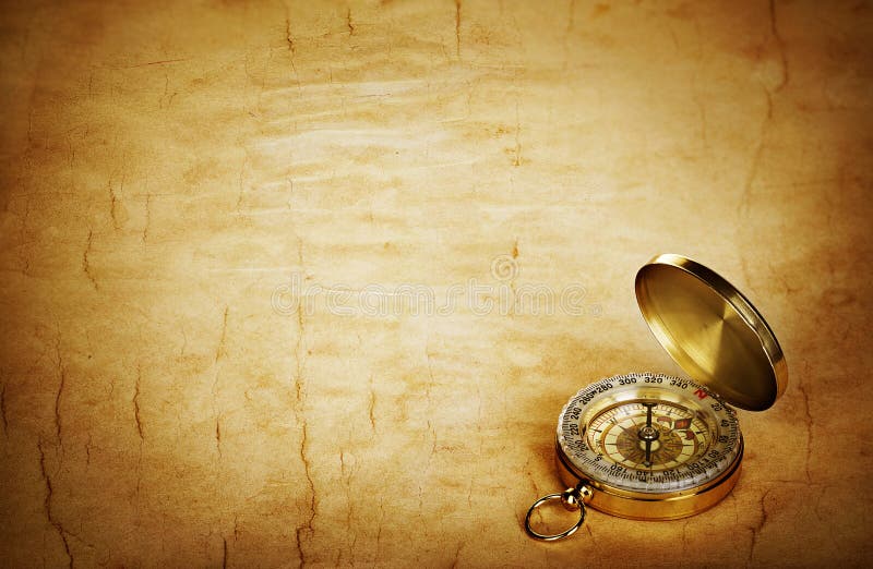 Ancient Brass Compass on Vintage Old Paper Background. Retro Stale ... Ancient Brass Compass on Vintage Old Paper Background. Retro Stale ...
