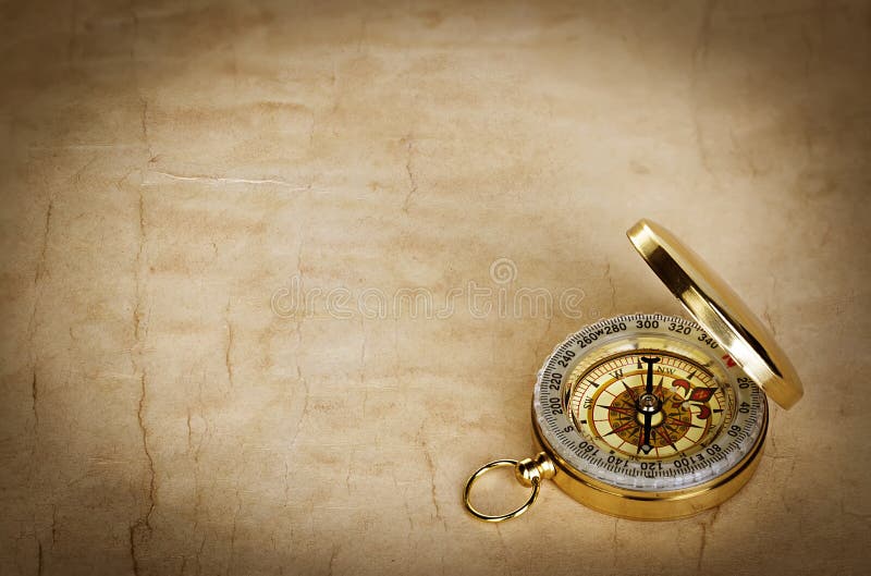 Ancient Brass Compass on Vintage Old Paper Background. Retro Stale ... Ancient Brass Compass on Vintage Old Paper Background. Retro Stale ...